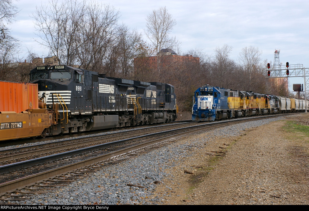 A five unit UP freight waits as an eastbound NS stack train heads towards the Meridian Speedway